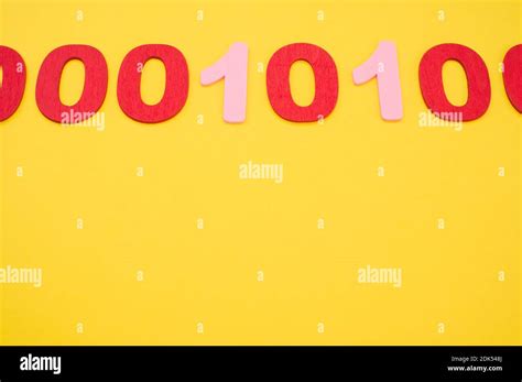 A Top View Of Red And Pink Binary Codes On A Bright Yellow Surface Stock Photo Alamy