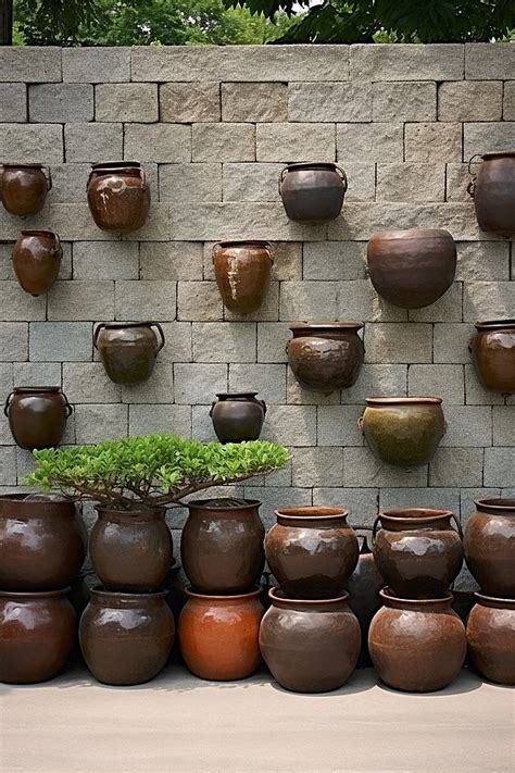 Multiple Bronze Pots On A Stone Wall Background Wallpaper Image For