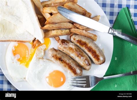 Classic British Supper Of Sausage Egg And Chips With White Sliced