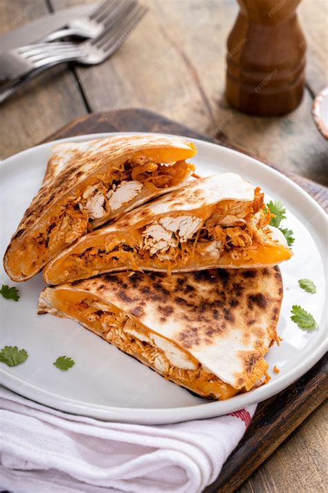 Premium Photo Pulled Chicken And Cheddar Quesadillas On A Plate