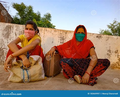 Indian Village Mother And Daughter Siting Together Holded Luggage At