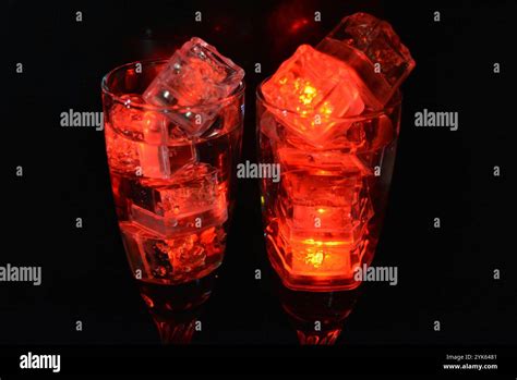 Red Glowing Ice Cubes Float In Champagne Glasses With A Drink Plastic Things Made In The Form