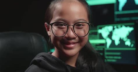 Asian Young Girl Hacker Hacking With Multiple Computer Screens And Smiling To Camera In Dark