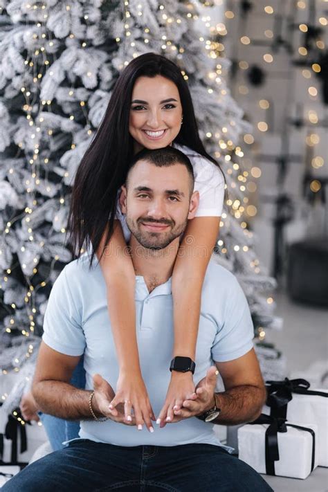 Happy Couple Of Man And Woman Hug Each Other And Stand In Front Of Fir