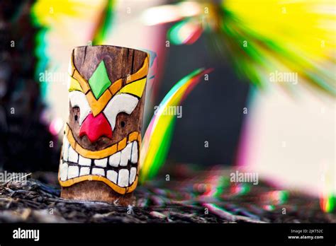 Tiki Carving In Front Of Colorful Palm Trees Stock Photo Alamy