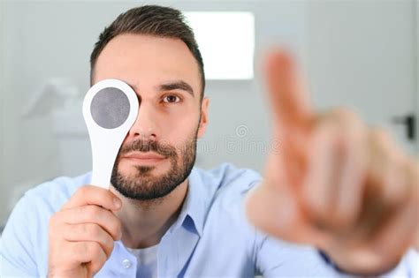 Test Of Sight Man Is Checking His Vision Indoors In The Clinic Stock