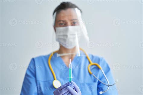 Doctor Holding Covid 19 Coronavirus Vaccine Over Light Background