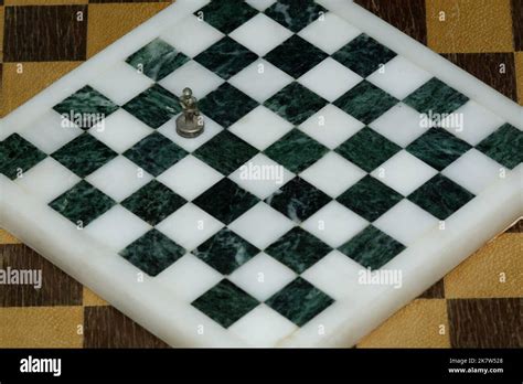 Lone Chess Pawn On A Square In An Empty Chess Board Highlighting A Feeling Of Isolation Black