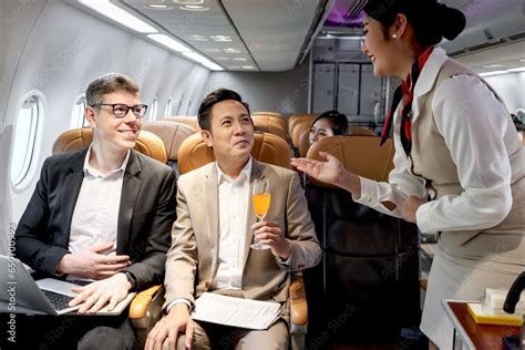 Businessman In Comfortable Seat Inside Airplane Female Cabin Crew Air