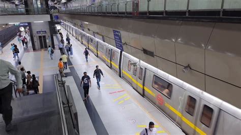 Passenger Walking At Metro Station With Metro Train Departing At Morning From Top Angle Stock