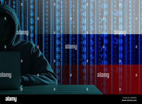 Silhouette Of Russian Hacker With Laptop On Dark Background With Space