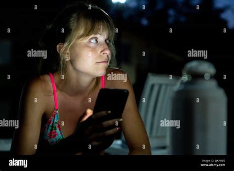 A Vertical Of A Young Caucasian Beautiful Female Scrolling Through Her