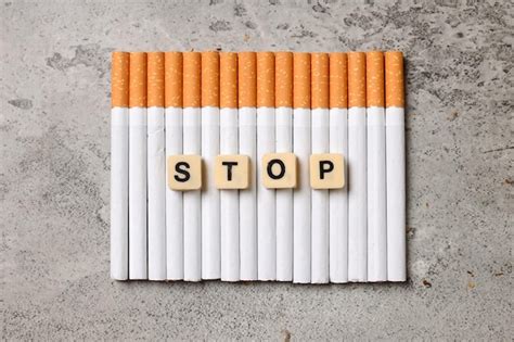 Premium Photo Cigarettes Arranged In A Row With Word Stop Stop