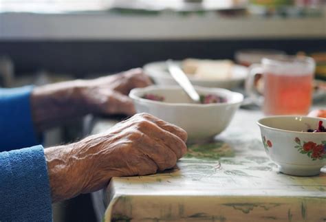 Premium Photo Close Up Of Senile Sinewy Hands At The Dinner Table