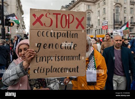 A Woman Holding A Placard Stop Occupation Genocide Imprisonment Displacement National