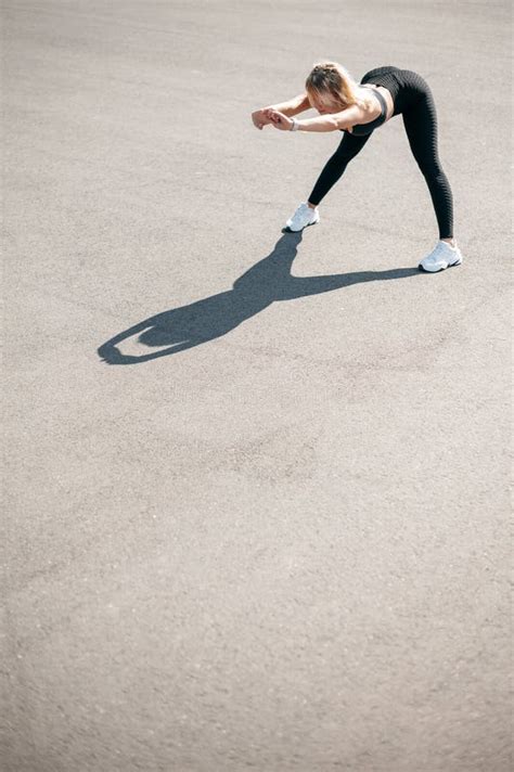 Sporty Woman Stretching And Warming Up Legs For Running Urban Fitness