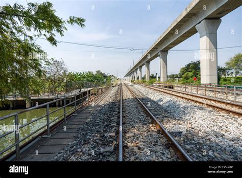 A Traditional Railway Track Lined With Gravel Ballast Running Parallel