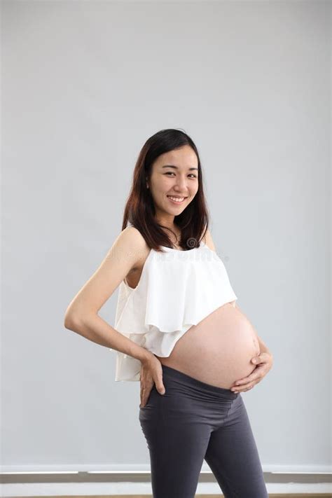 Full Length Shot Of Portrait Of Asian Young Pregnant Belly Wife And