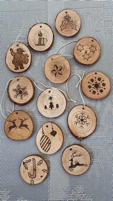 Wood Burned Ornaments Are Arranged On A Blue Table Cloth With Twine And
