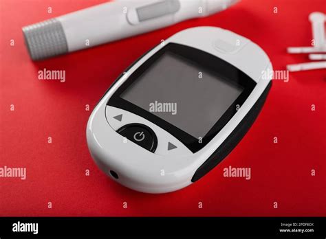 Digital Glucometer Lancets And Pen On Red Background Diabetes Control