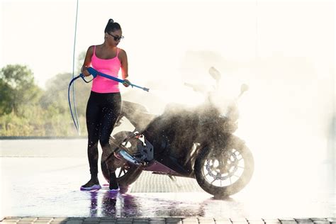 Premium Photo Beautiful Girl Washes A Motorcycle At Self Service Car