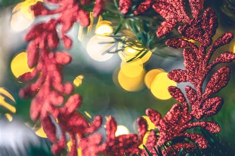 Free Photo Decorative Red Wreath On A Christmas Tree With Bokeh Lights