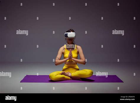 Young Slim Girl In Yellow Sportswear Training Doing Yoga Exercises In