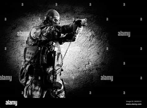 Special Unit Soldier Stands With A Pistol In His Hands And Aims At The