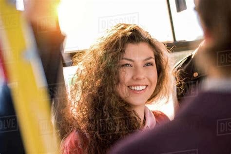 Beautiful Brunette Girl With Curly Hair Smiling In City Bus Royalty