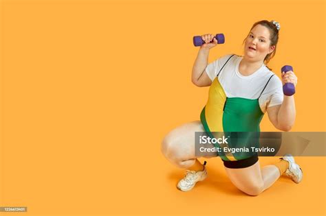 밝은 쾌활한 뚱뚱한 소녀는 스포츠에 종사하고 카메라를 보고있다 25 29세에 대한 스톡 사진 및 기타 이미지 25 29세