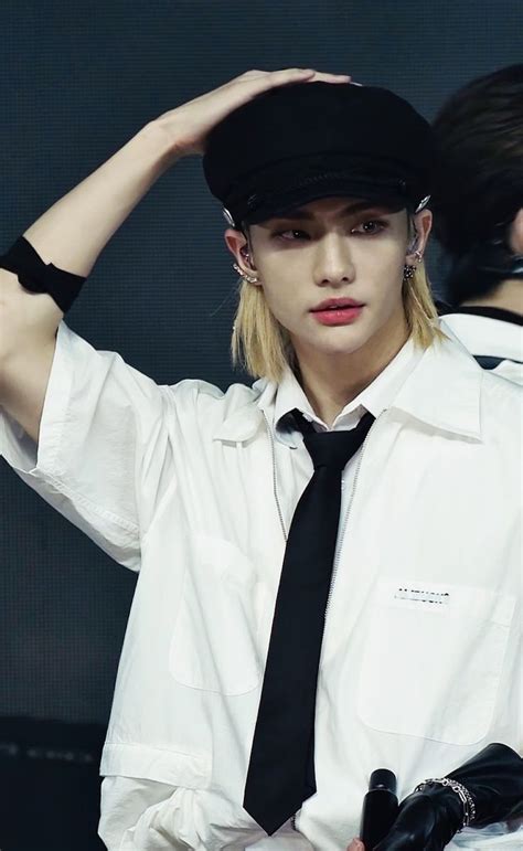 A Man Wearing A White Shirt And Black Tie Holding His Hands Up To His Head