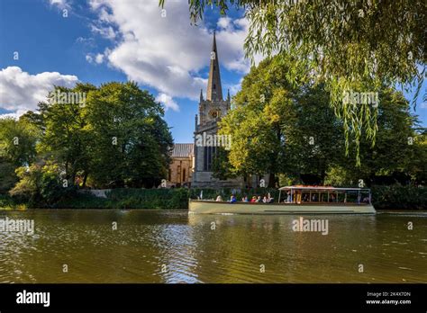 A River Cruise Boat Passing Holy Trinity Church At Stratford Upon Avon