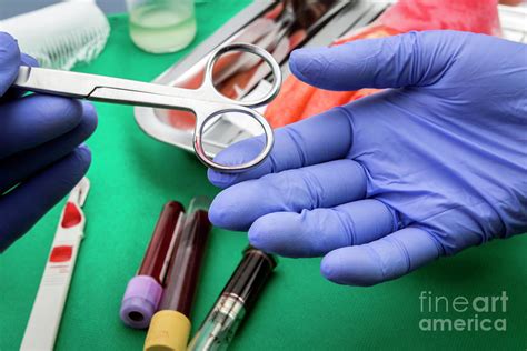 Passing Surgical Instruments By Science Photo Library