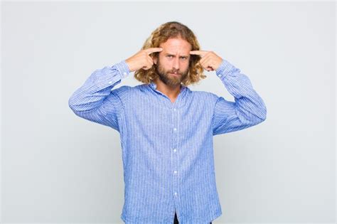 Premium Photo Blonde Man With A Serious And Concentrated Look