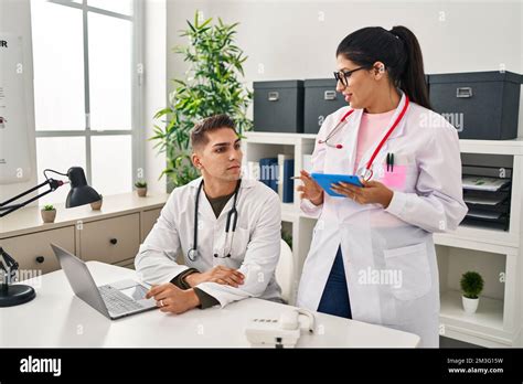 Man And Woman Wearing Doctor Uniform Using Touchpad Working At Clinic Stock Photo Alamy