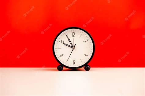 Premium Photo White Alarm Clock Isolated On Red Background