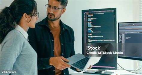 Software Engineering Team Engaged In Problemsolving And Code Analysis