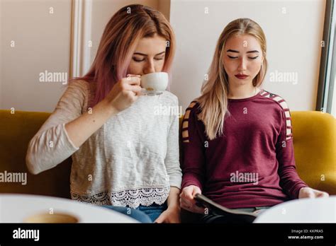 Two Girls Meat At Coffee Place And Talk To Each Other Make Conversation Stock Photo Alamy