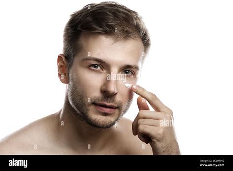 Mens Beauty Young Man Is Applying Moisturizing And Anti Aging Cream