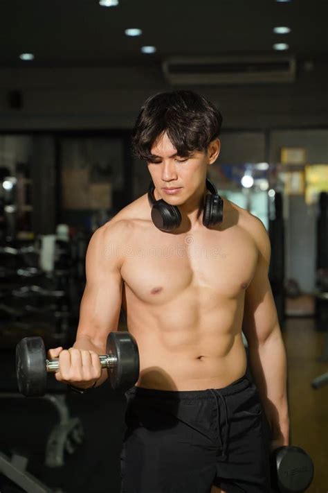 Closeup And Crop Perfect Body Of Asian Guy Relaxing With Mobile Phone