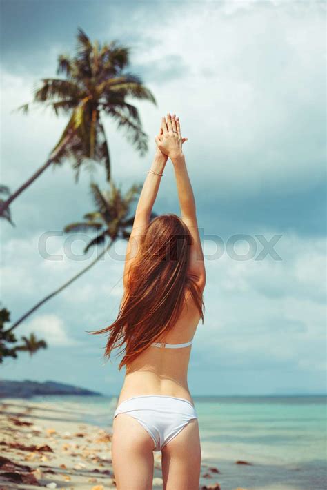 Back View Of Woman In Bikini Standing On Beach Near Ocean Stock Image