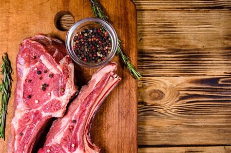 Premium Photo Raw Ribeye Steak Glass Jar With Spices And Rosemary On