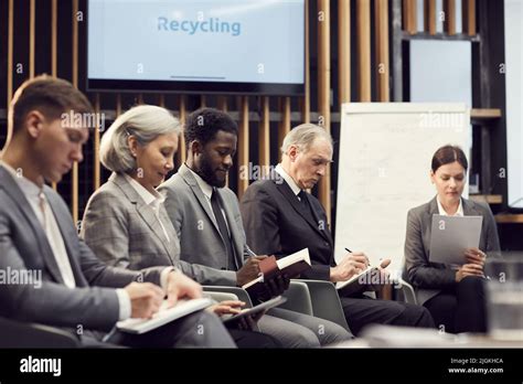Group Of Content Multi Ethnic Business People In Formal Outfits Sitting