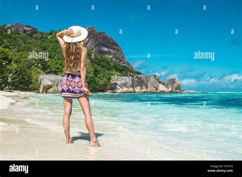 A Young Girl Standing In Shallow Water On La Digue Island Seychelles