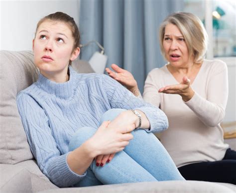 Mature Mother And Adult Daughter Scandal In Domestic Interior Stock