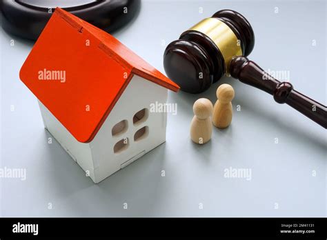 Model Of House With Two Figures And Gavel Separation Or Inheritance