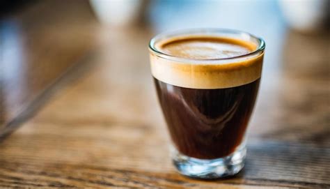 Premium Photo Steaming Espresso Shot In A Crystalclear Glass