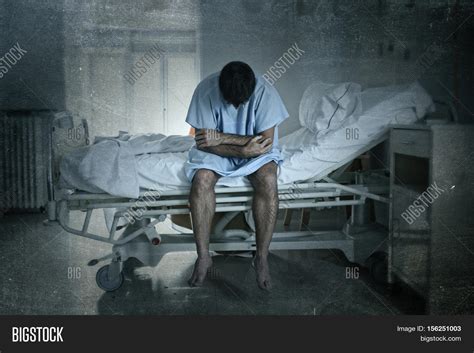 Young Desperate Man Sitting At Hospital Bed Alone Sad And Devastated