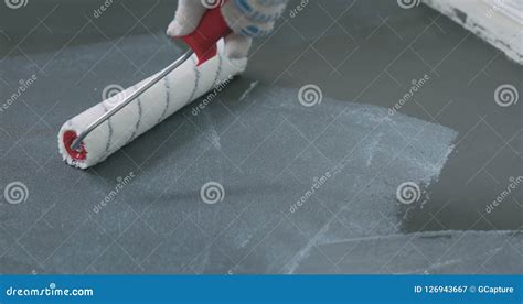 Closeup Applying Protective Coating On The Concrete Floor Stock Image