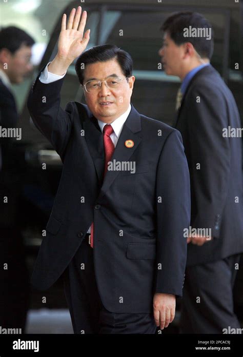 Chinese President Hu Jintao Waves As He Arrives At The National
